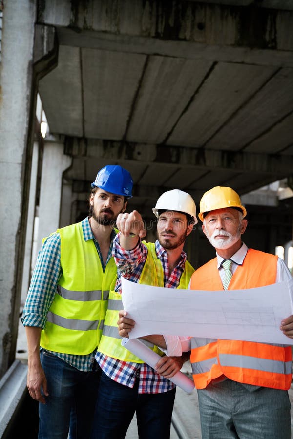 Confident Team of Architects and Engineers Working Together on ...