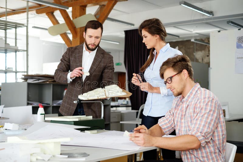 Confident Team of Engineers Working Together in a Architect Studio ... Confident Team of Engineers Working Together in a Architect Studio ...