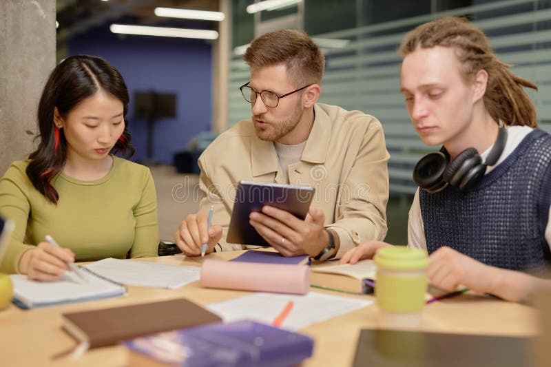 Male Teacher Helping Students with Task at Workshop Stock Image - Image ...