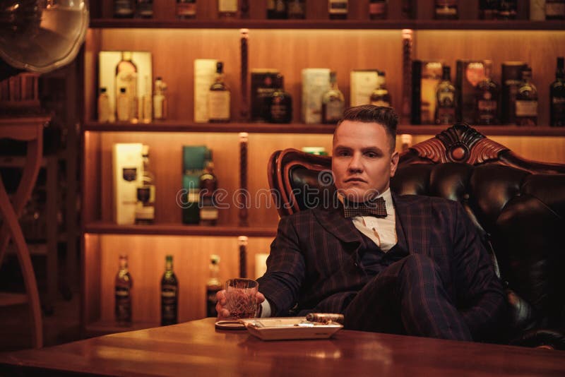 Confident Upper Class Man with Glass of Beverage in Gentlemen`s Club ...