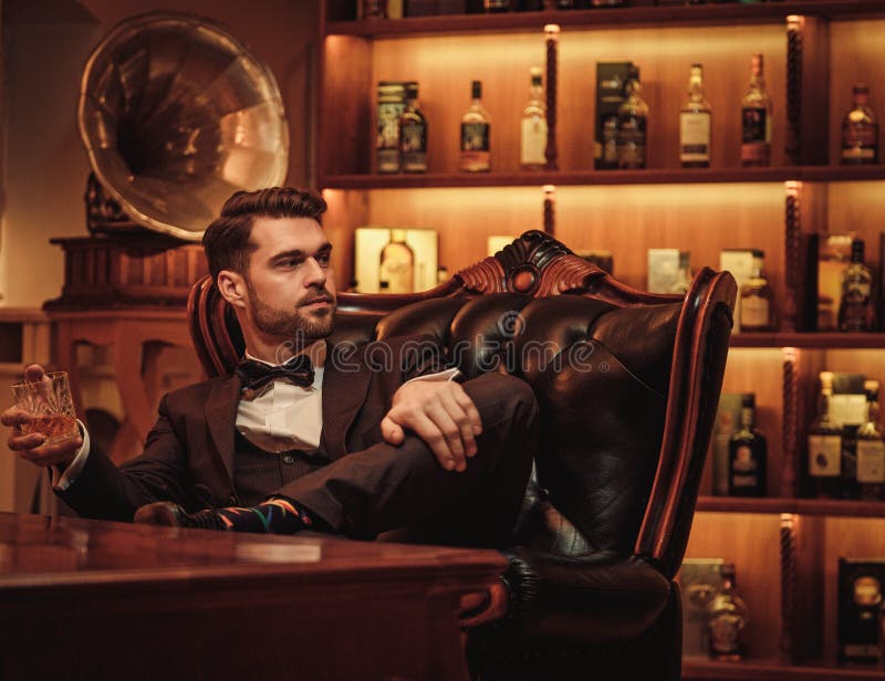Confident Upper Class Man with Glass of Beverage in Gentlemen`s Club ...