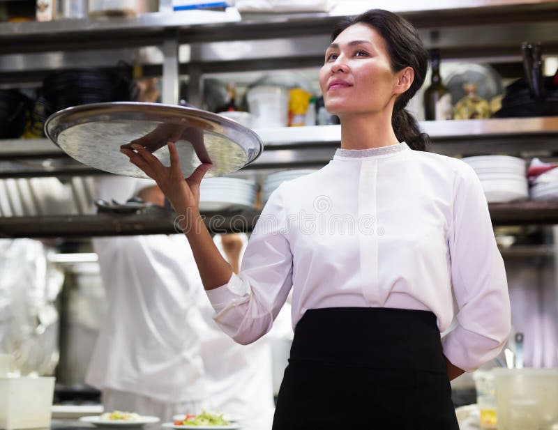Confident Waitress Holding Cooked Meals in Restaurant Kitchen Stock ...