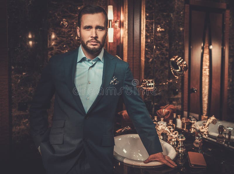 Confident Well-dressed Man with Glass of Whisky in Luxury Apartment ...