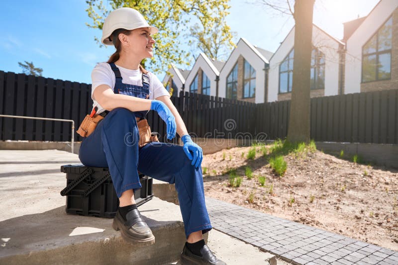 Confident Woman Building Engineer in Hardhat and Overall Sitting and ...