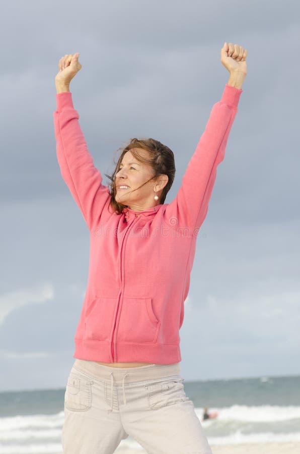 Confident Woman in Winning Pose at Beach Stock Photo - Image of ...