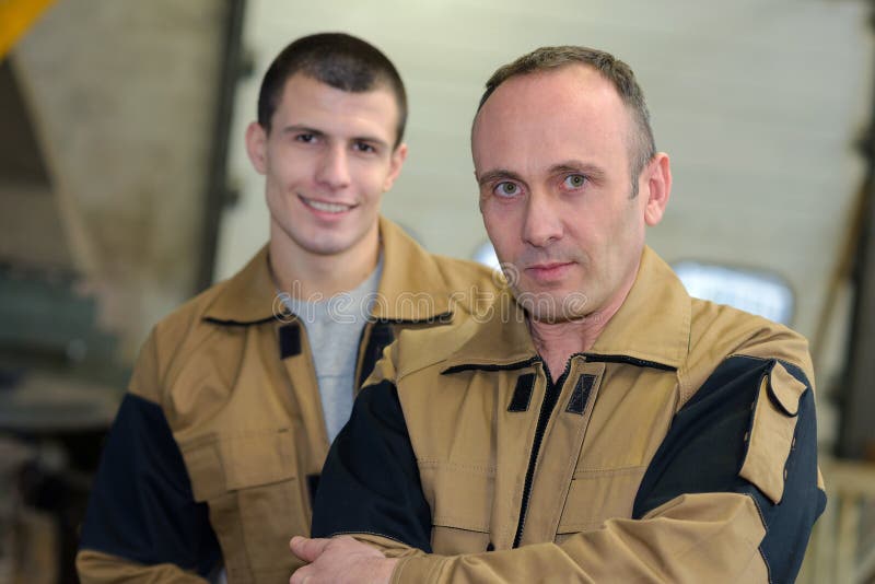 Confident Worker and Apprentice Stock Photo - Image of table, standing ...