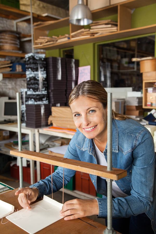 Confident Worker Smiling while Binding Papers Stock Photo - Image of ...