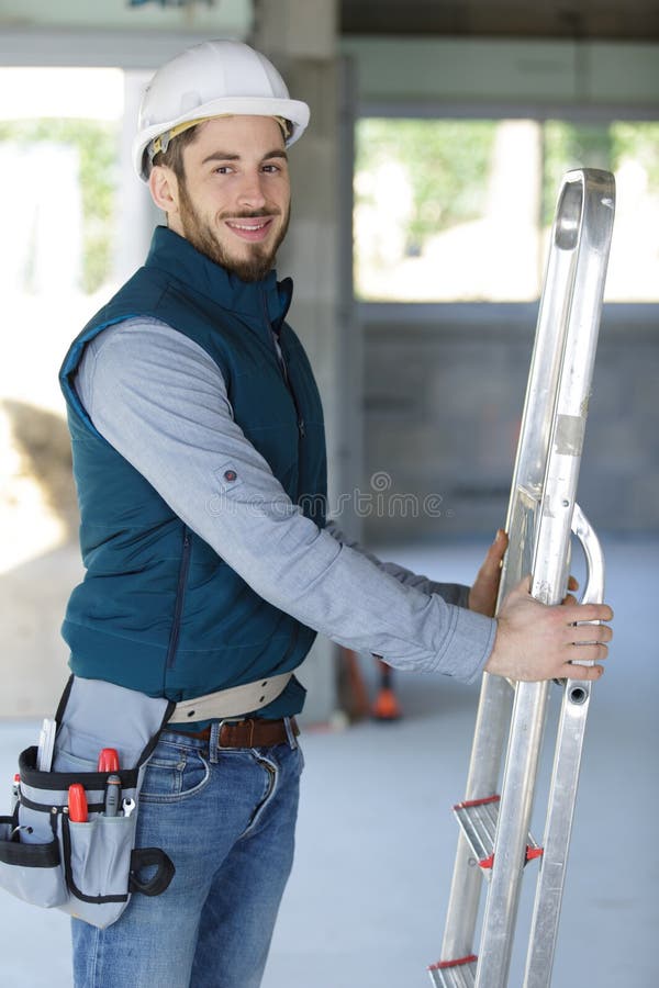 Confident Young Builder on Ladder Stock Image - Image of ladder ...