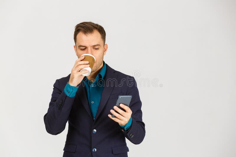 Confident Young Businessman Using Cell Phone and Drinking Coffee Stock ...