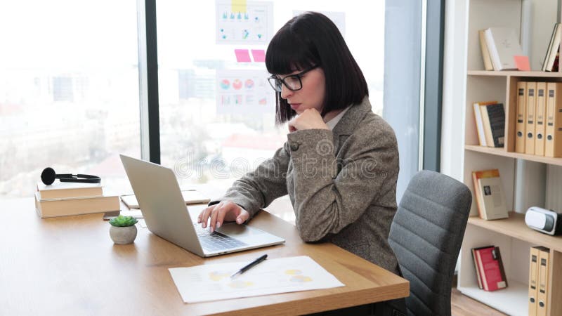 Confident Young Employee in Formal Wear Unlocking Laptop Keyboard ... Confident Young Employee in Formal Wear Unlocking Laptop Keyboard ...