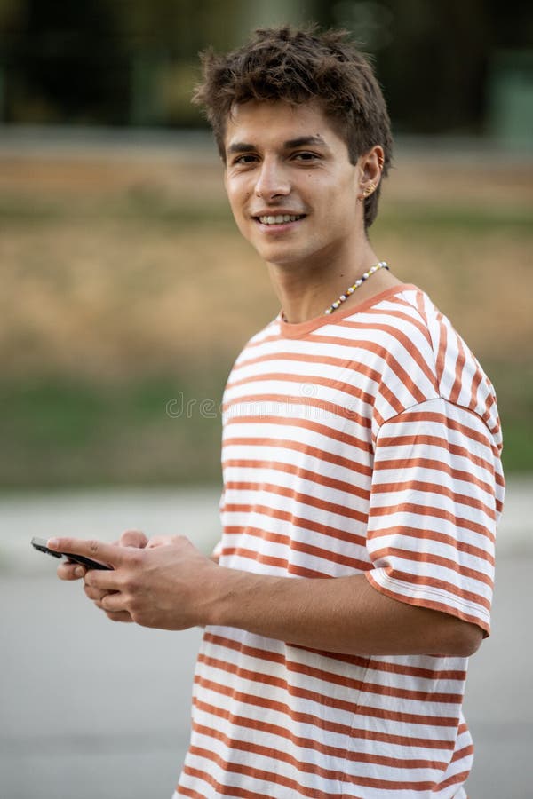 Confident Young Guy Looking at Camera and Texting with Smartphone ...