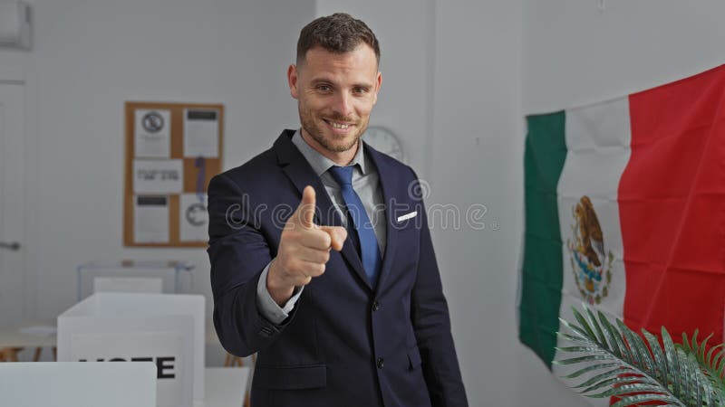 Confident Young Hispanic Man in a Suit Pointing at the Camera with ...