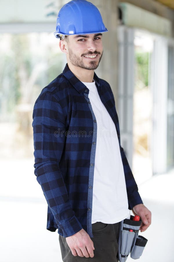 Confident Young Male Builder Posing Indoors Stock Photo - Image of ...