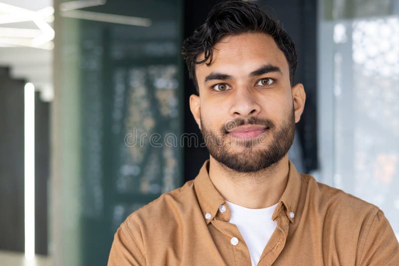 Confident Young Man with Beard Smiling in a Modern Office Environment ...
