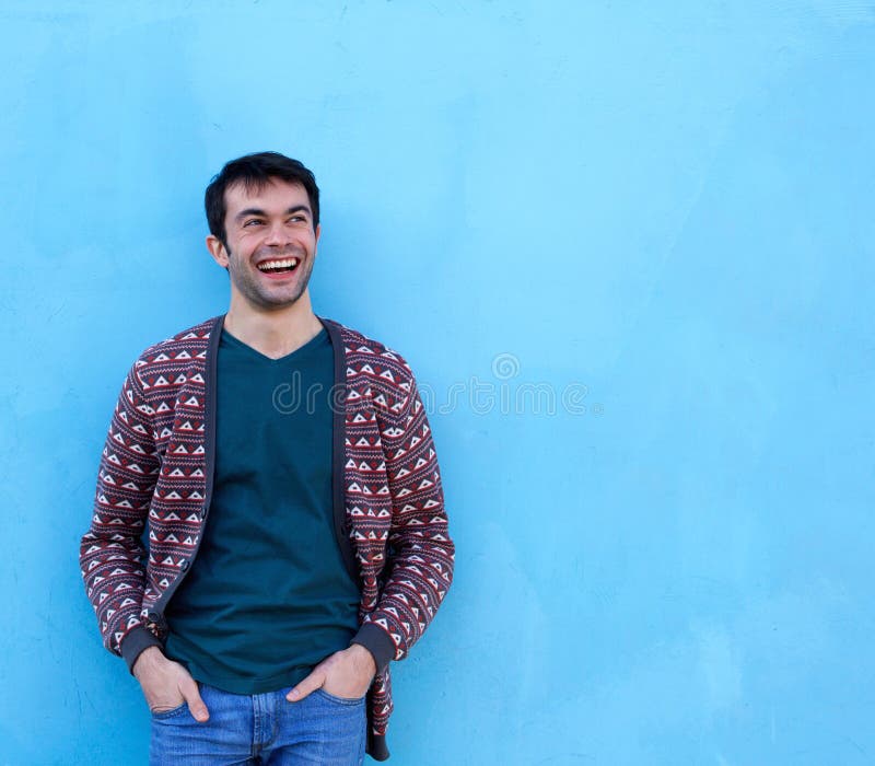 Confident Young Man Smiling Against Blue Background Stock Image - Image ...