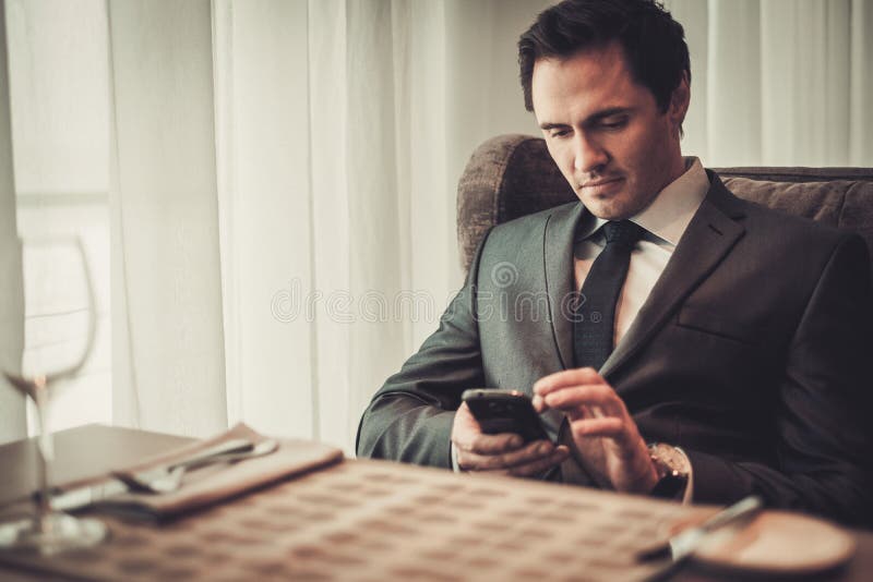 Confident Young Man Using Smart Phone in Restaurant Stock Photo - Image ...