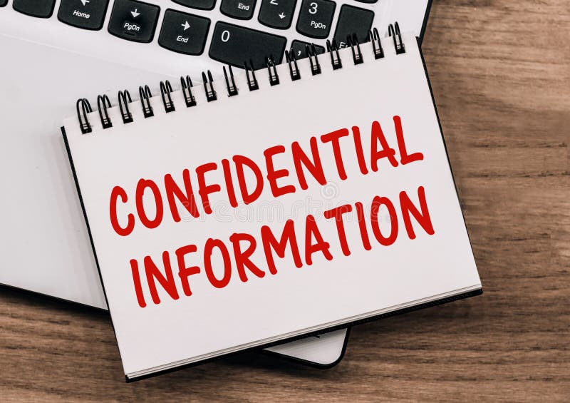 CONFIDENTIAL INFORMATION - Inscription on Notepad on Laptop Keyboard ...