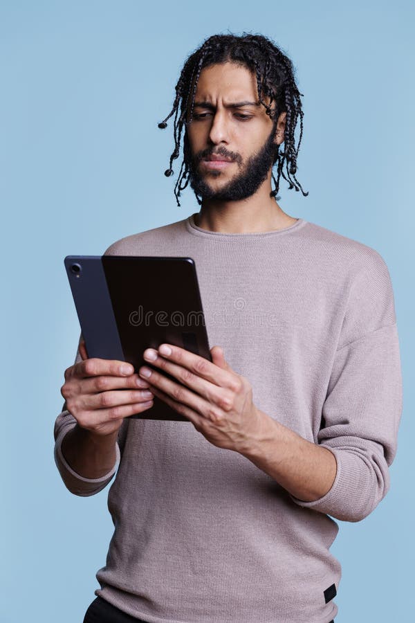 Confused Arab Man Scrolling Software App on Digital Tablet Stock Photo ...