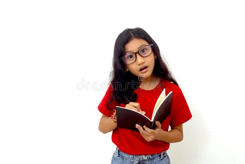 Confused Asian Elementary Student Standing while Holding a Book. Study ...