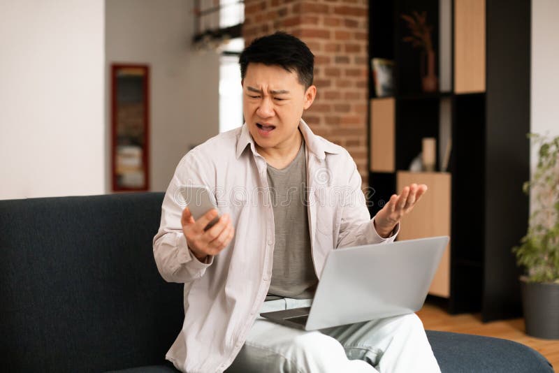 Confused Male Office Employee Sitting at Wokplace and Looking at ...