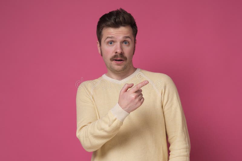 Confused Bewildered Young Man Pointing Fingers at Copy Space Aside ...