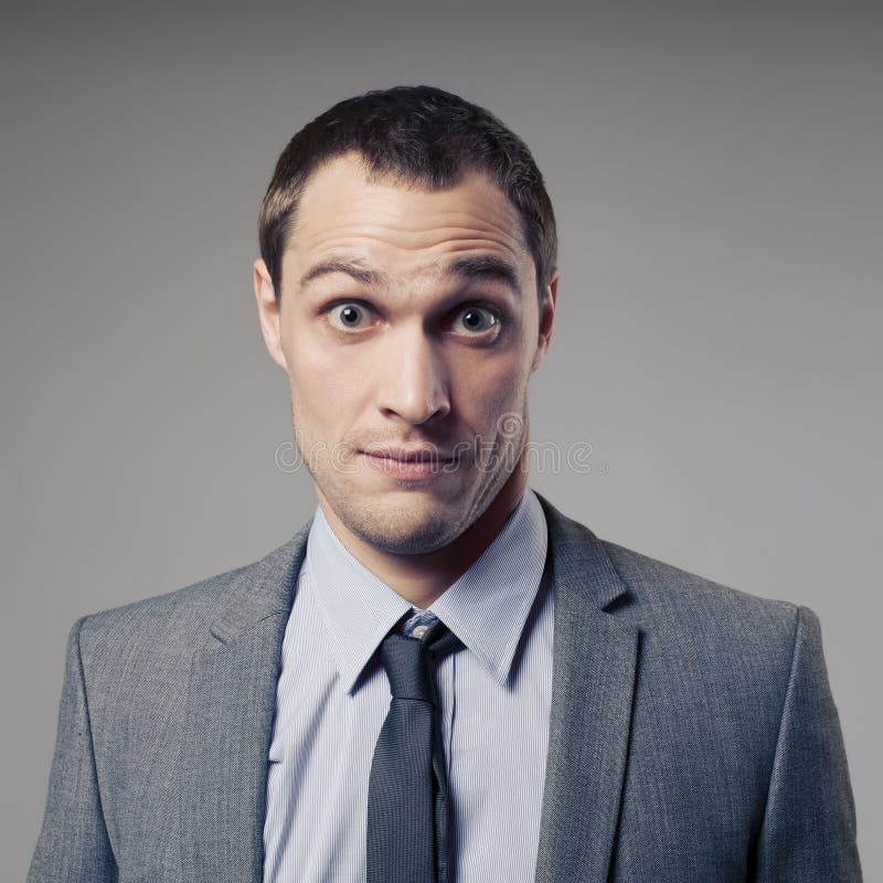 Confused Businessman on Gray Background Stock Photo - Image of clueless ...