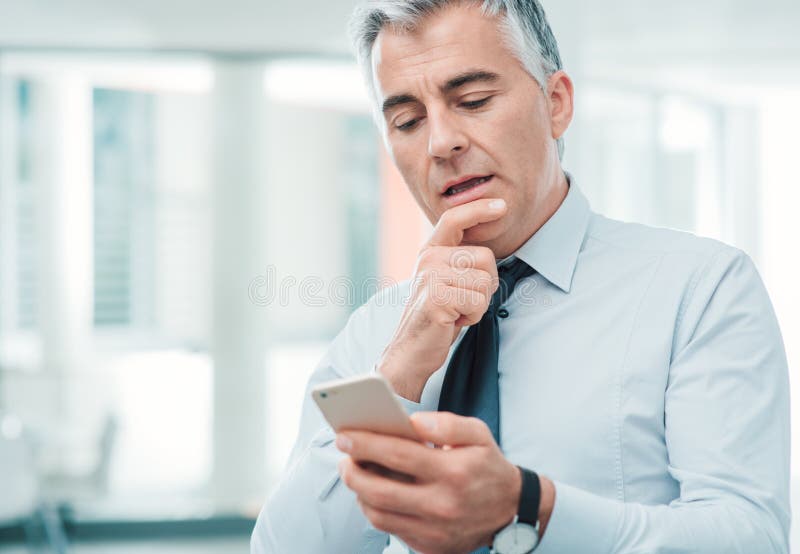 Confused Businessman Using a Smart Phone Stock Photo - Image of formal ...