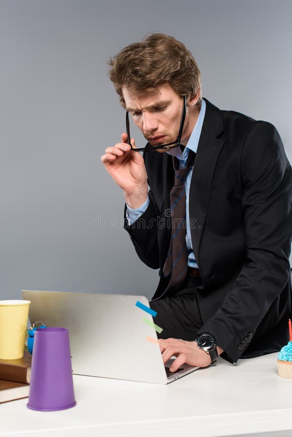 Confused Businessman Sitting at Workplace and Using Laptop. Stock Image ...
