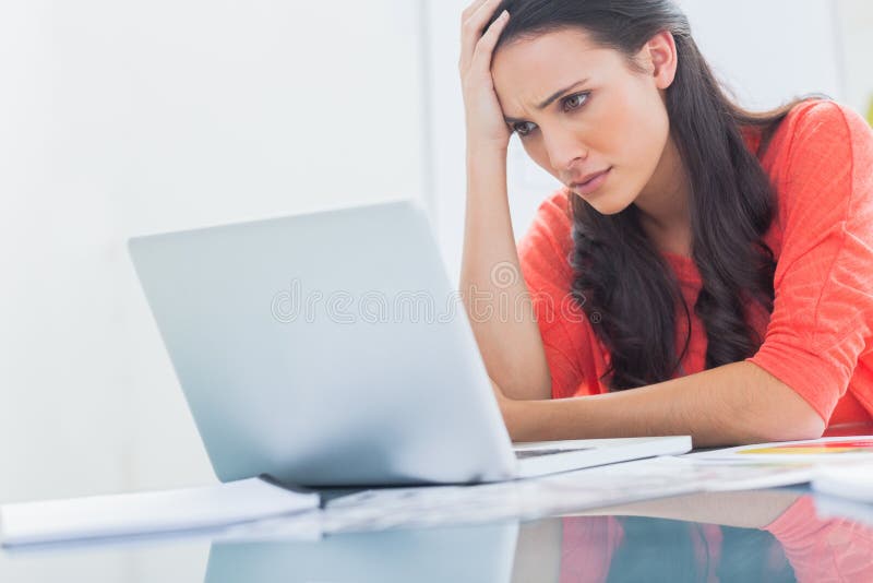 Confused Designer Looking at Her Laptop Stock Photo - Image of ...