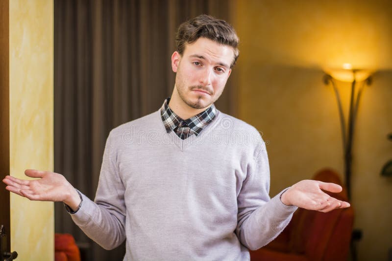 Confused Or Doubtful Young Man Scratching His Head And Looking Up Stock