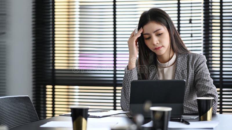 Confused Female Entrepreneur Sitting at Her Workplace Thinking of ...