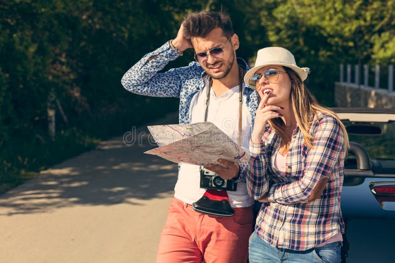 Confused Friends with Map Looking at the Map at Cabriolet Car Stock ...