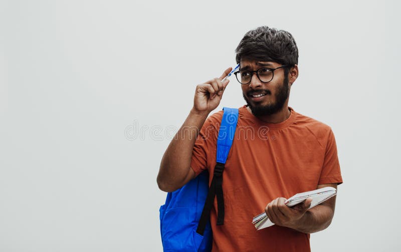 Confused Indian Student with Blue Backpack, Glasses and Notebook Posing ...