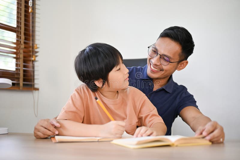 Confused Little Son Asking a Question while His Dad is Helping Him Do ...