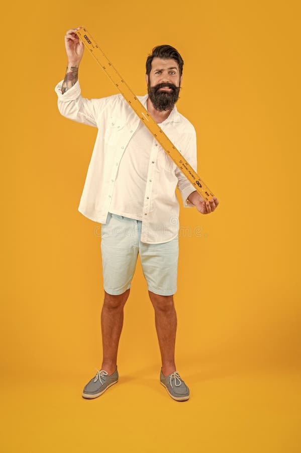 Confused Man Hold School Ruler Isolated on Yellow. Man Hold School ...