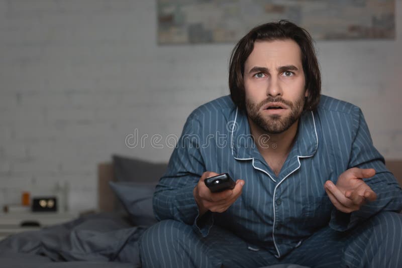 Confused Man with Insomnia Holding Remote Stock Image - Image of blur ...