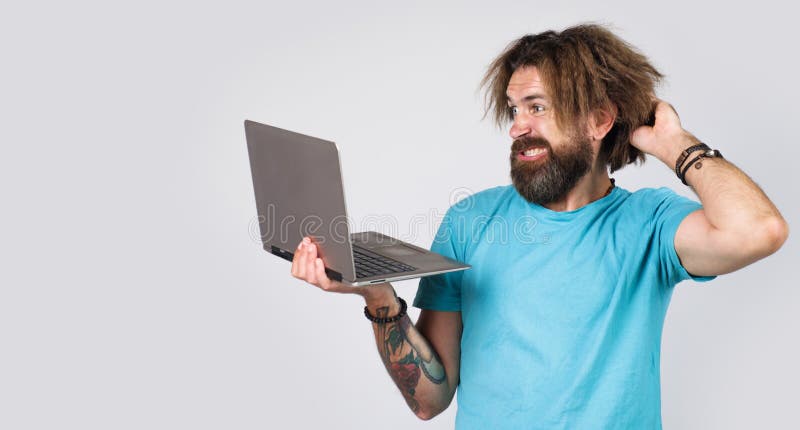 Confused Man with Laptop Computer Looking at Display. Bearded Male with ...
