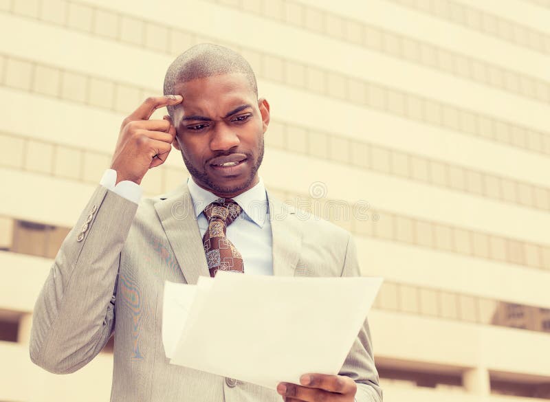 Confused Man Looking at Documents Outside Corporate Office Building ...