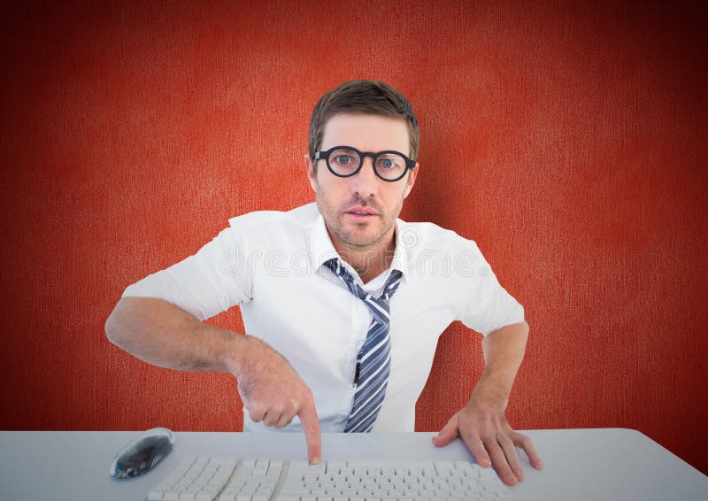 Confused Man Pointing To Computer Keyboard at Desk Stock Photo - Image ...