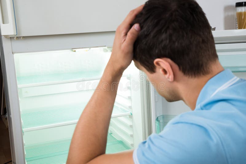 Confused Man Scratching Head while Looking at Empty Refrigerator Stock ... Confused Man Scratching Head while Looking at Empty Refrigerator Stock ...