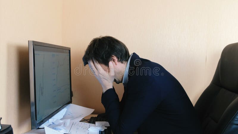 Confused Man Working at the Computer. Desperate Tears Paper and Throws ...