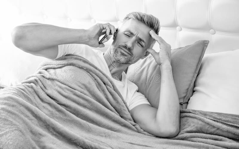Confused Mature Man in Bed Speaking on Phone Stock Image - Image of ...
