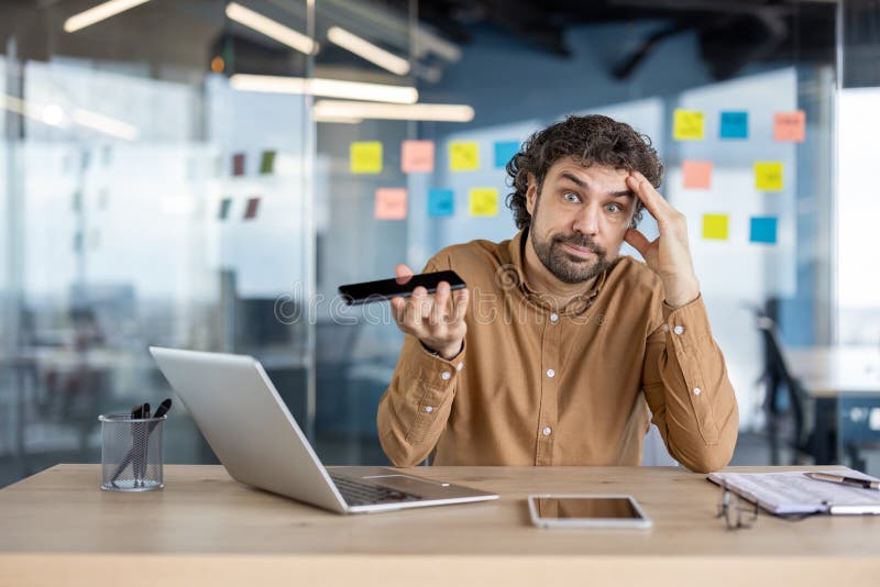 Confused Mature Man with Smartphone at Modern Office Stock Photo ...