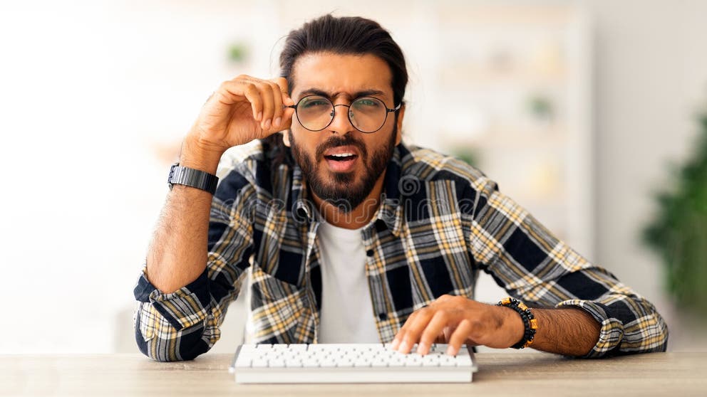 Confused Middle-eastern Man Programmer Sitting at Worktable, Touching ...