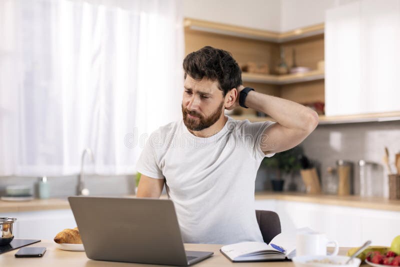 Confused Millennial Caucasian Man with Beard Scratching His Head, Works ...