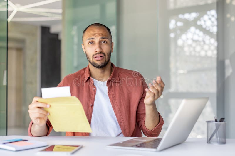 Confused Office Worker Holding an Envelope in a Modern Office Space ...
