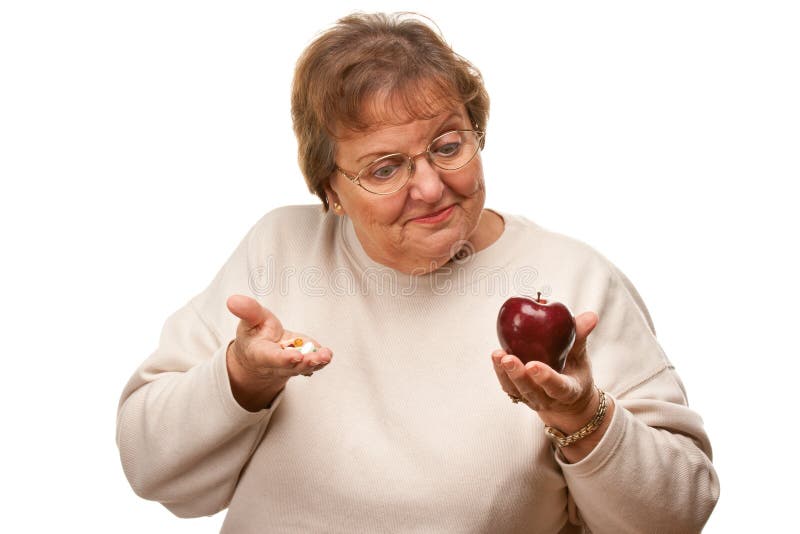 Confused Senior Woman Holding Apple and Vitamins Stock Image - Image of ...