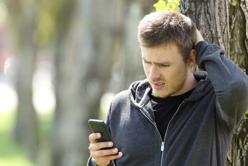 Confused Teen Reading Message in a Smart Phone Stock Photo - Image of ...