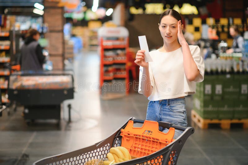 Confused and Upset Woman with a Check in Grocery Store. Stock Photo ...