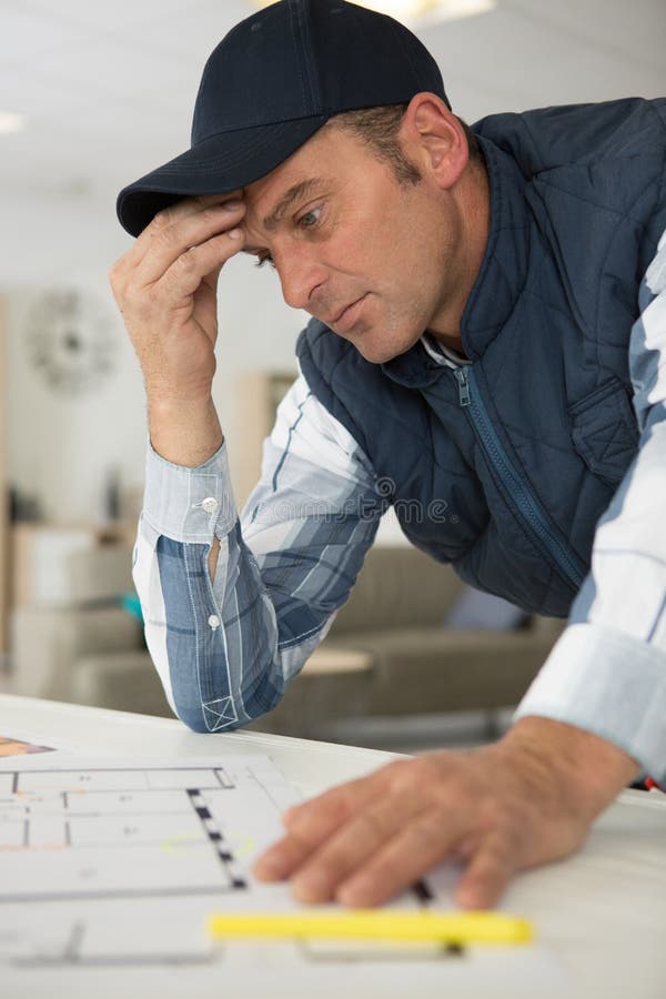 Confused Worker Checking Plan Stock Photo - Image of looking, studio ...